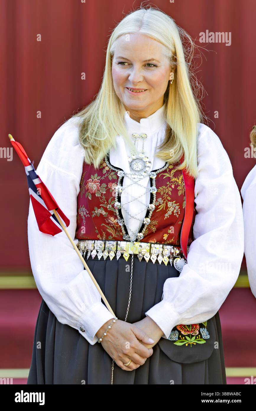 Asker, Norway 17 May 2025 Crown Princess Mette Marit greets the children parada outside their ...
