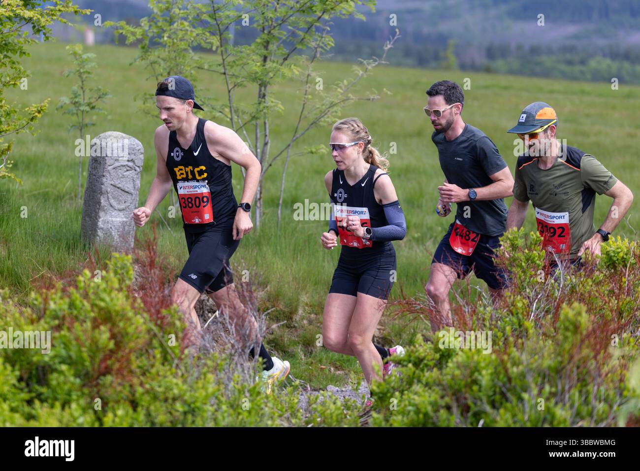 Masserberg, Germany. 17th May, 2025. Runners pass a historic boundary ...