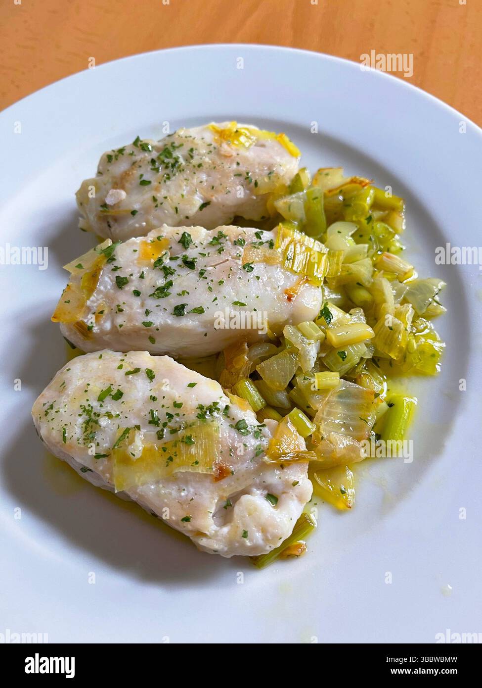 Grilled hake loin with garlic and onion Stock Photo - Alamy