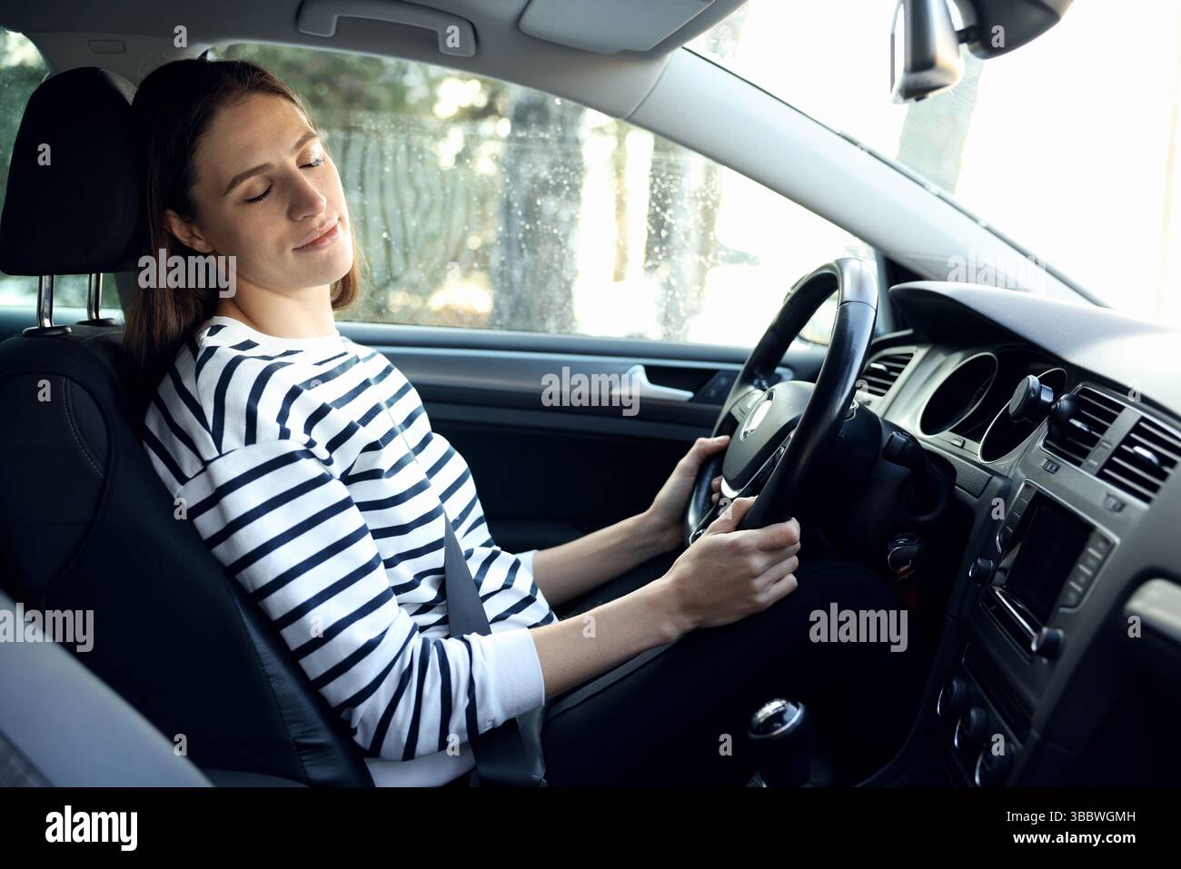 Tired driver sleeping in her modern car Stock Photo - Alamy