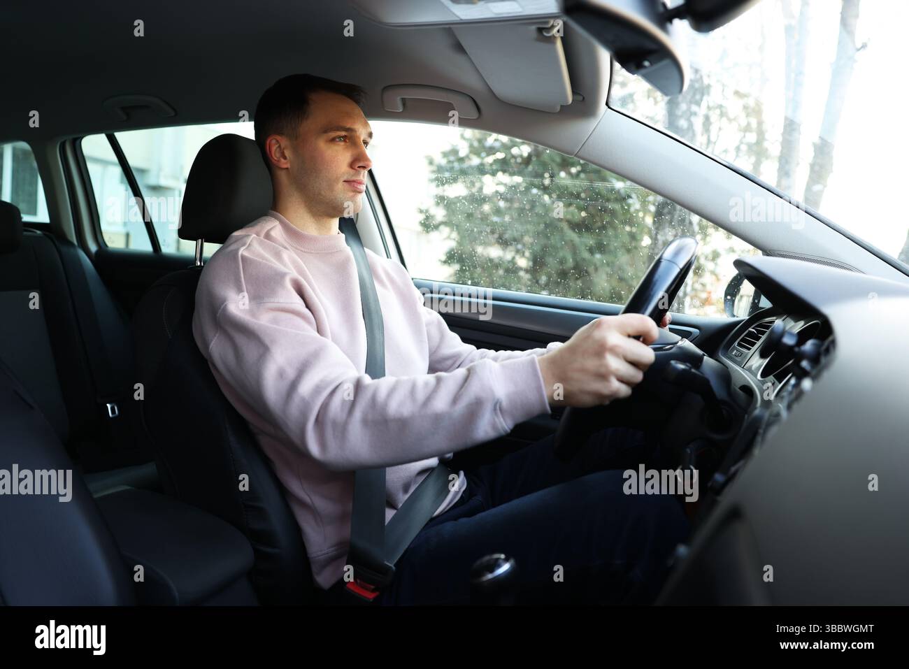 Driver behind steering wheel of modern car Stock Photo - Alamy
