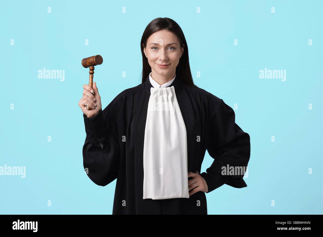 Judge with mallet on light blue background Stock Photo - Alamy