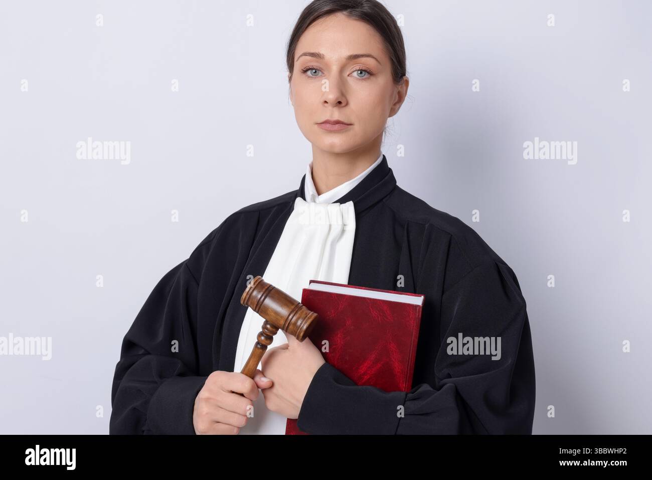 Judge with mallet and book on light background Stock Photo - Alamy