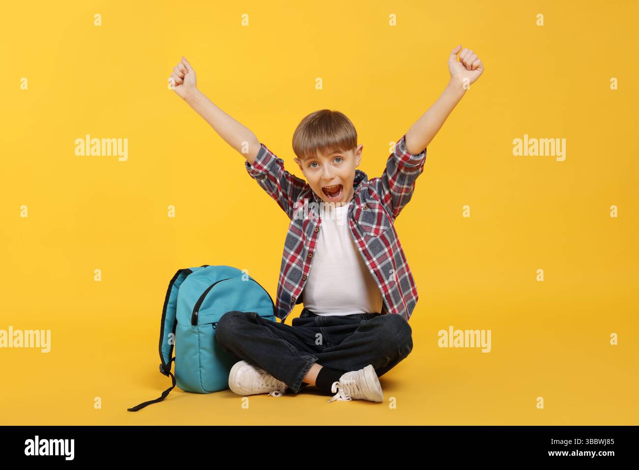 Cute emotional schoolboy with backpack orange background Stock Photo ...