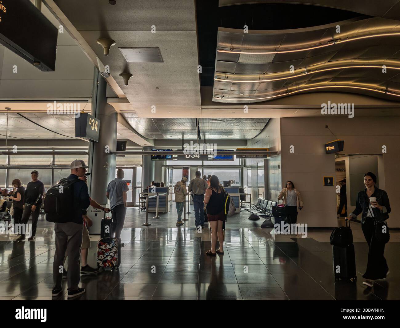 LAS VEGAS, AUGUST 21, 2024: Passengers with wait at gate D34 inside ...