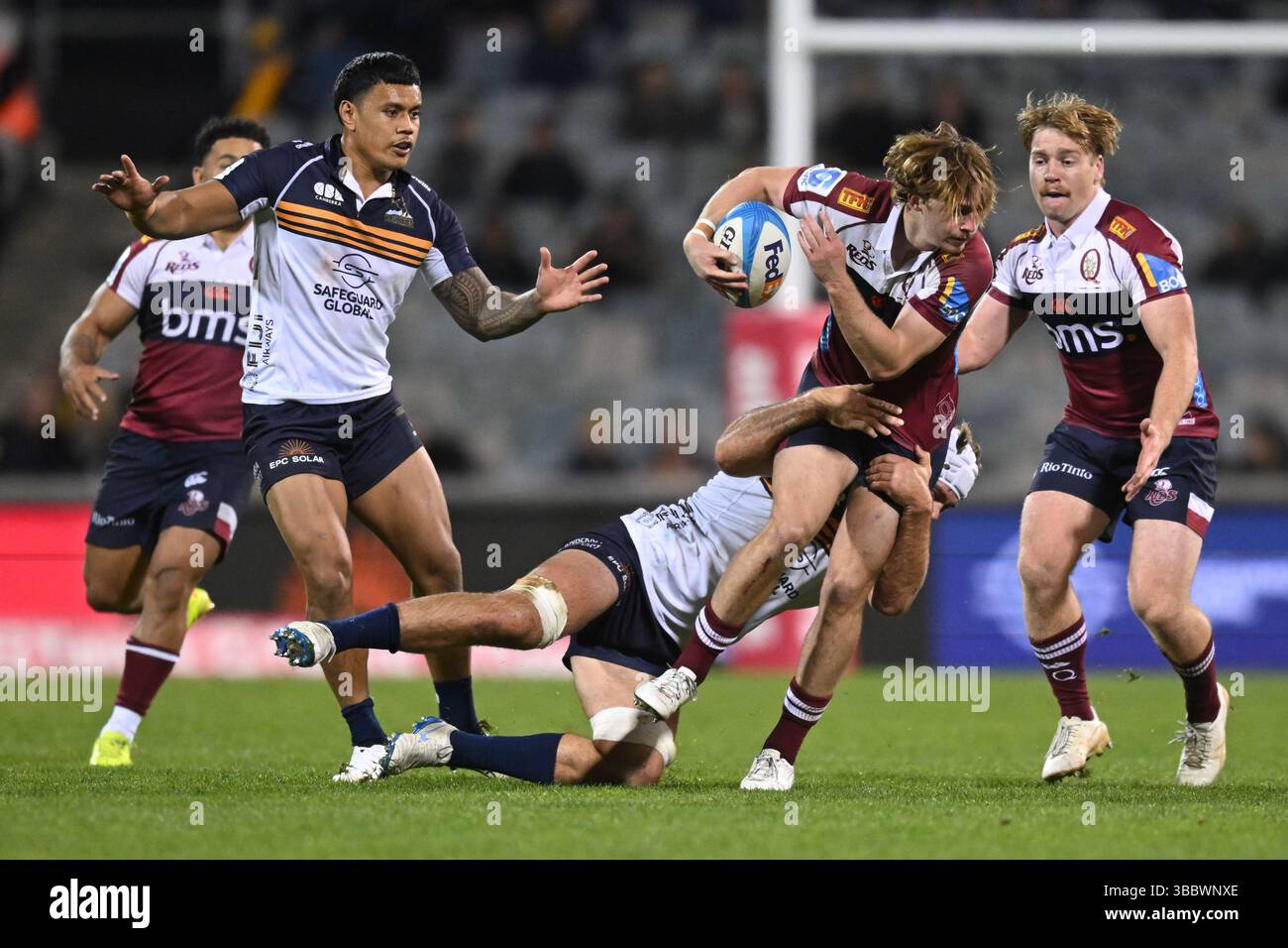 Canberra, Australia. 17th May, 2025. Tim Ryan of the Reds is tackled ...