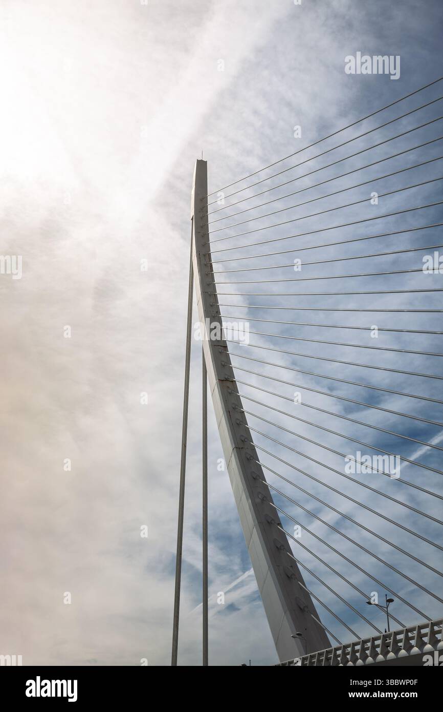 Elegant white cable-stayed bridge pylon rises into high cloud ...