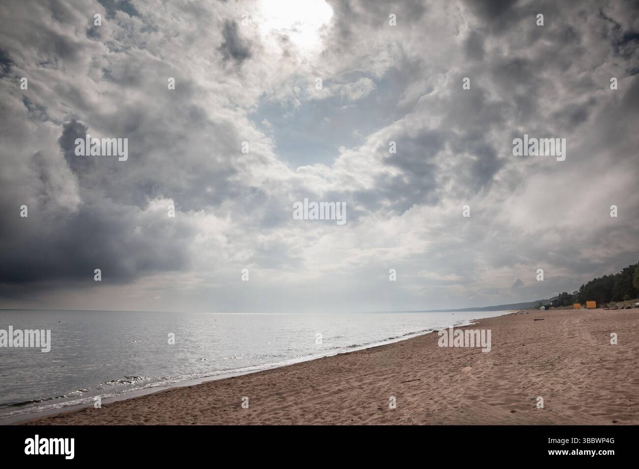 Low clouds break above Saulkrasti's broad Baltic strand; shifting light ...