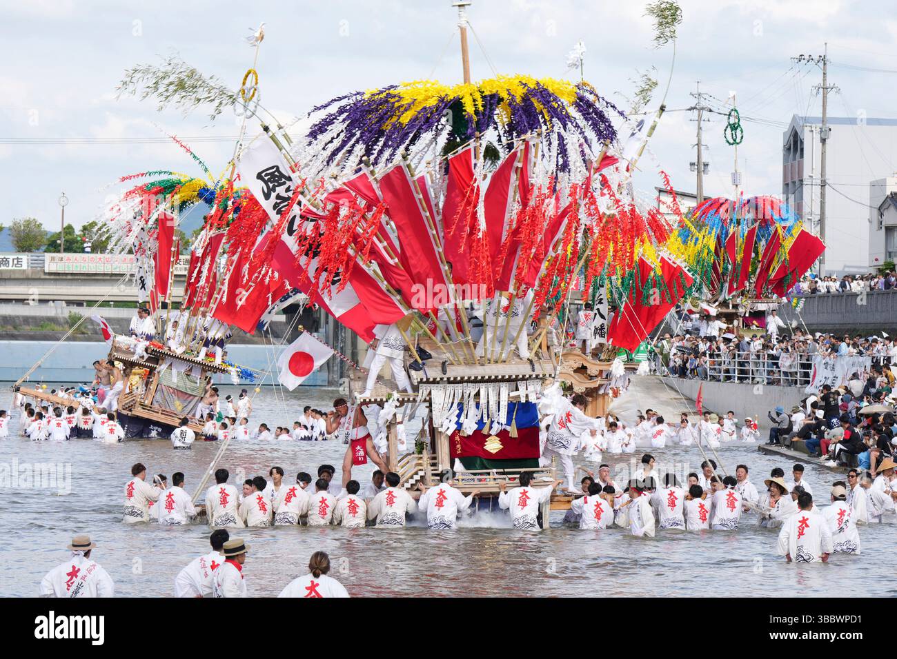 Colorful Yamakasa valiantly cross the Hikoyama River during a Japanese ...