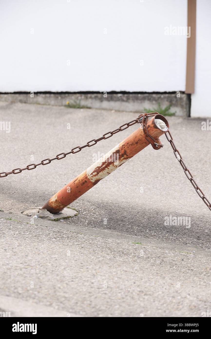 A rusty chain is attached to a metal pole Stock Photo - Alamy