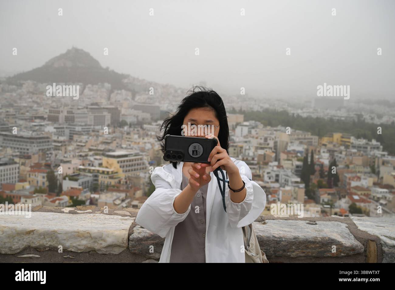 Athens, Greece, 16 May 2025. A visitor takes pictures while Athens is ...