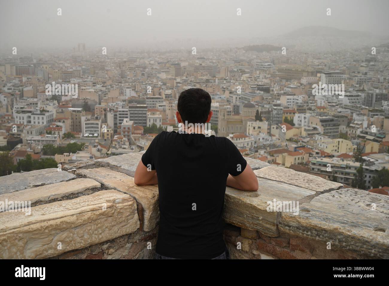 Athens, Greece, 16 May 2025. A visitor looks over the city while Athens ...
