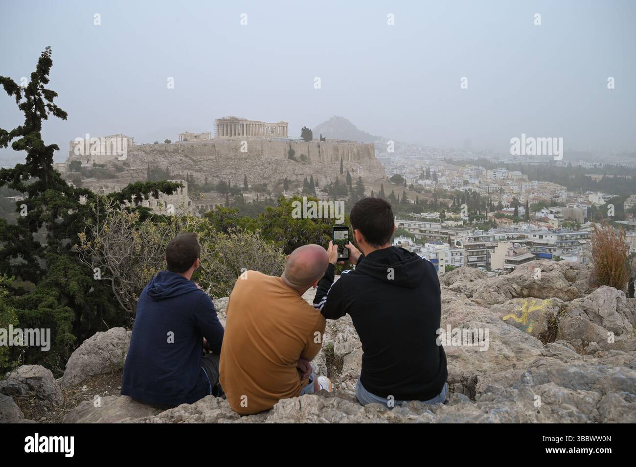 Athens, Greece, 16 May 2025. Visitors take pictures of the ancient ...