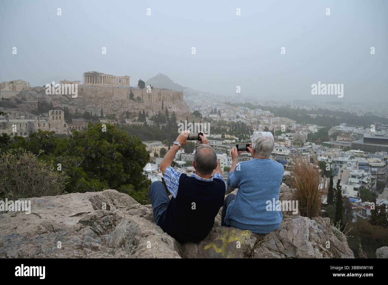 Athens, Greece, 16 May 2025. Visitors take pictures of the ancient ...