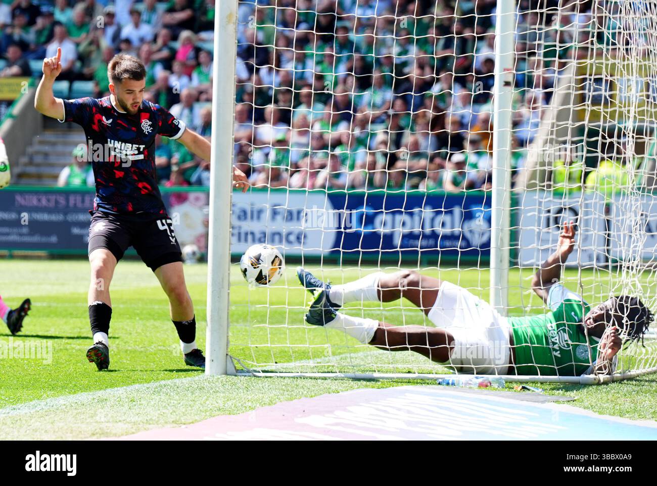 Hibernian's Rocky Bushiri (right) clears the ball off the line as ...