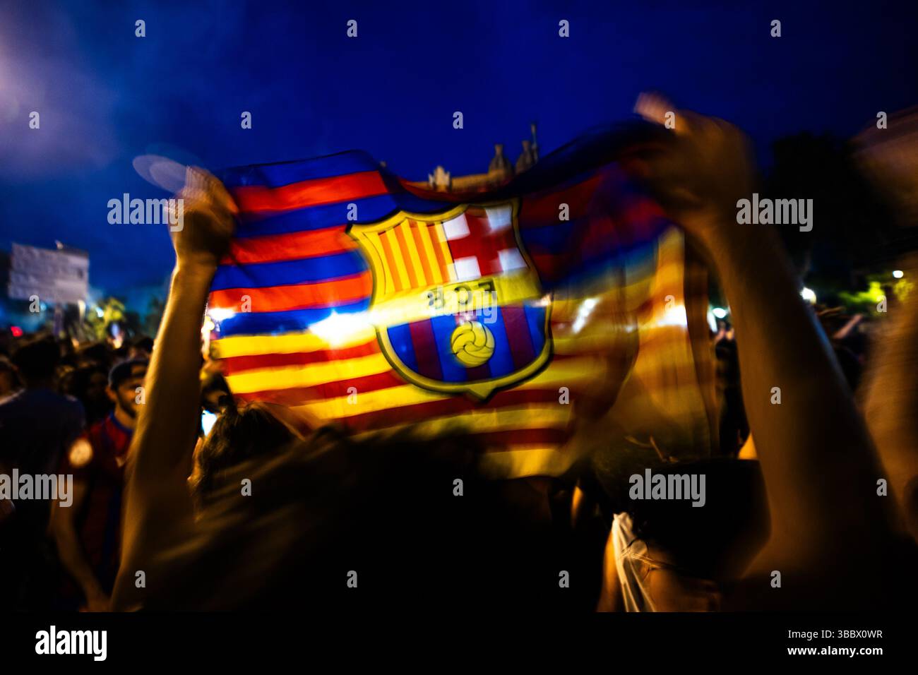 Barcelona, Spain. 16th May, 2025. A fan holds the FC Barcelona flag ...