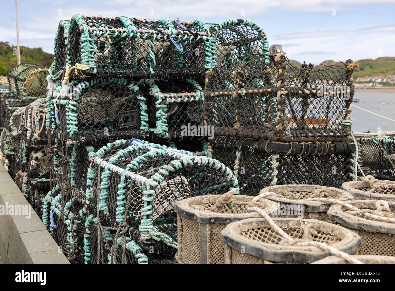 Crab traps stacked on a Harbor. Pile of lobster pots, sea side fishing ...
