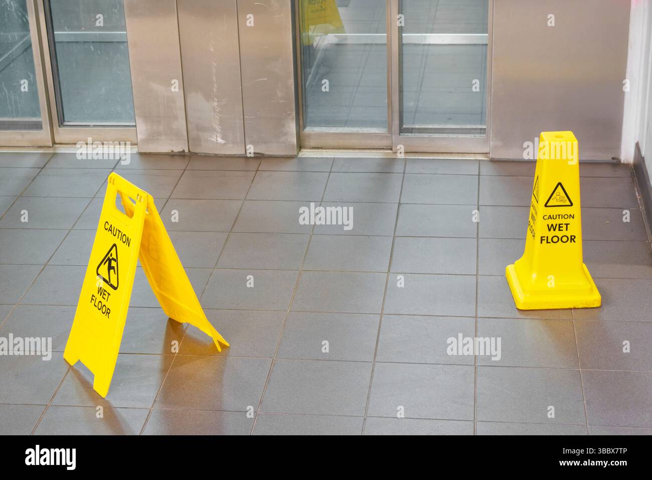 Caution wet floor cone safety notice at public stair Stock Photo - Alamy