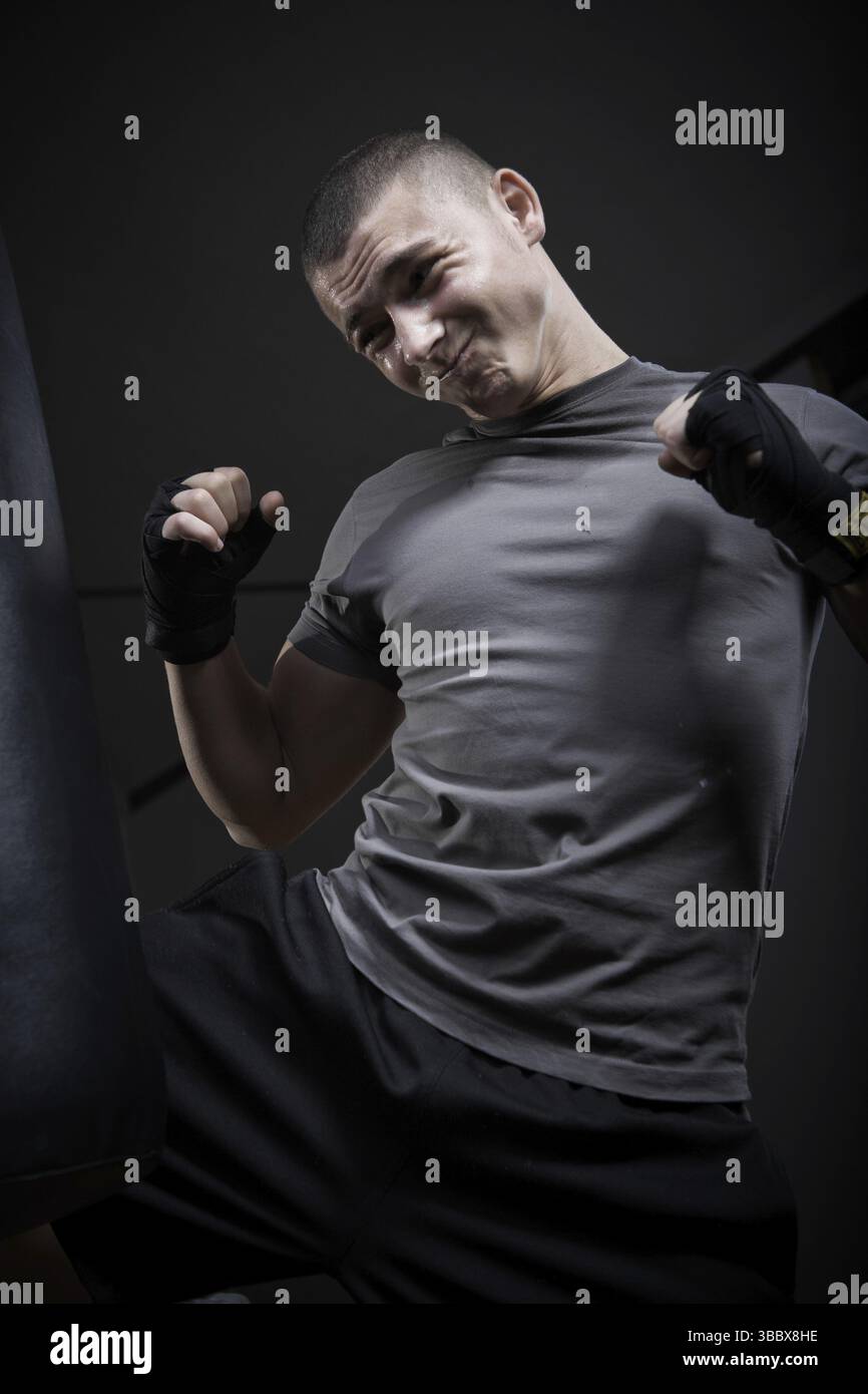 Portrait of a young boxer in front of dark background Stock Photo - Alamy