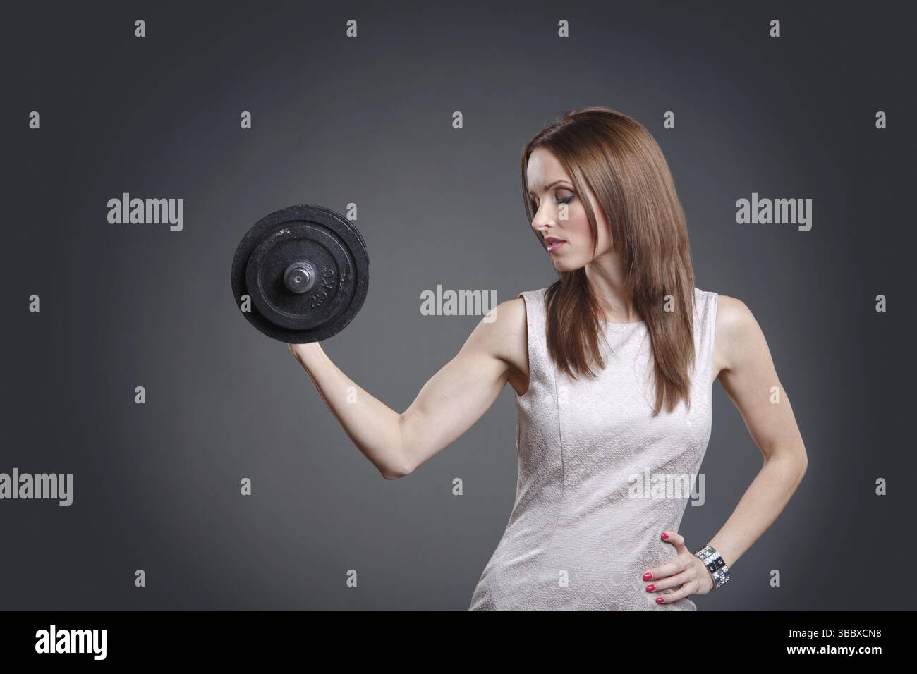 Studio portrait of a female office worker with strong biceps Stock ...