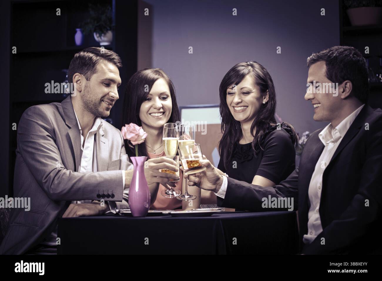 Two couples by eating in a restaurant Stock Photo - Alamy