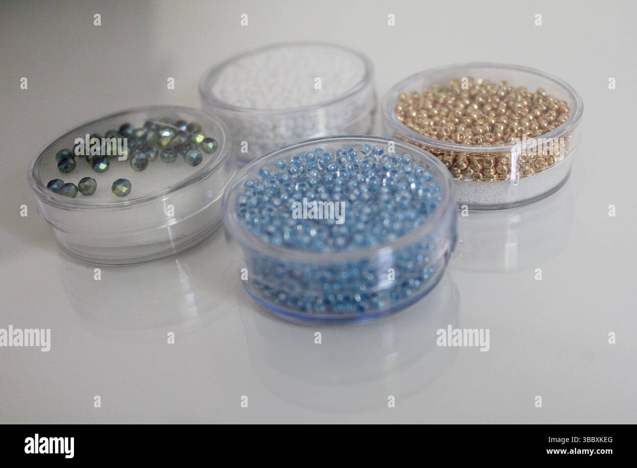 Colorful Glass Seed Beads in Transparent Plastic Containers on White ...