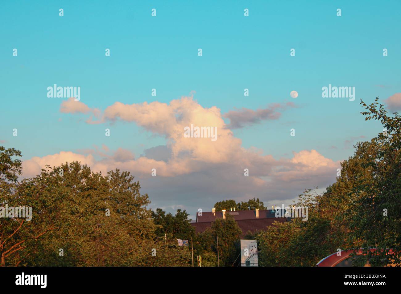 Early Evening Sky with Clouds and Moon Stock Photo - Alamy