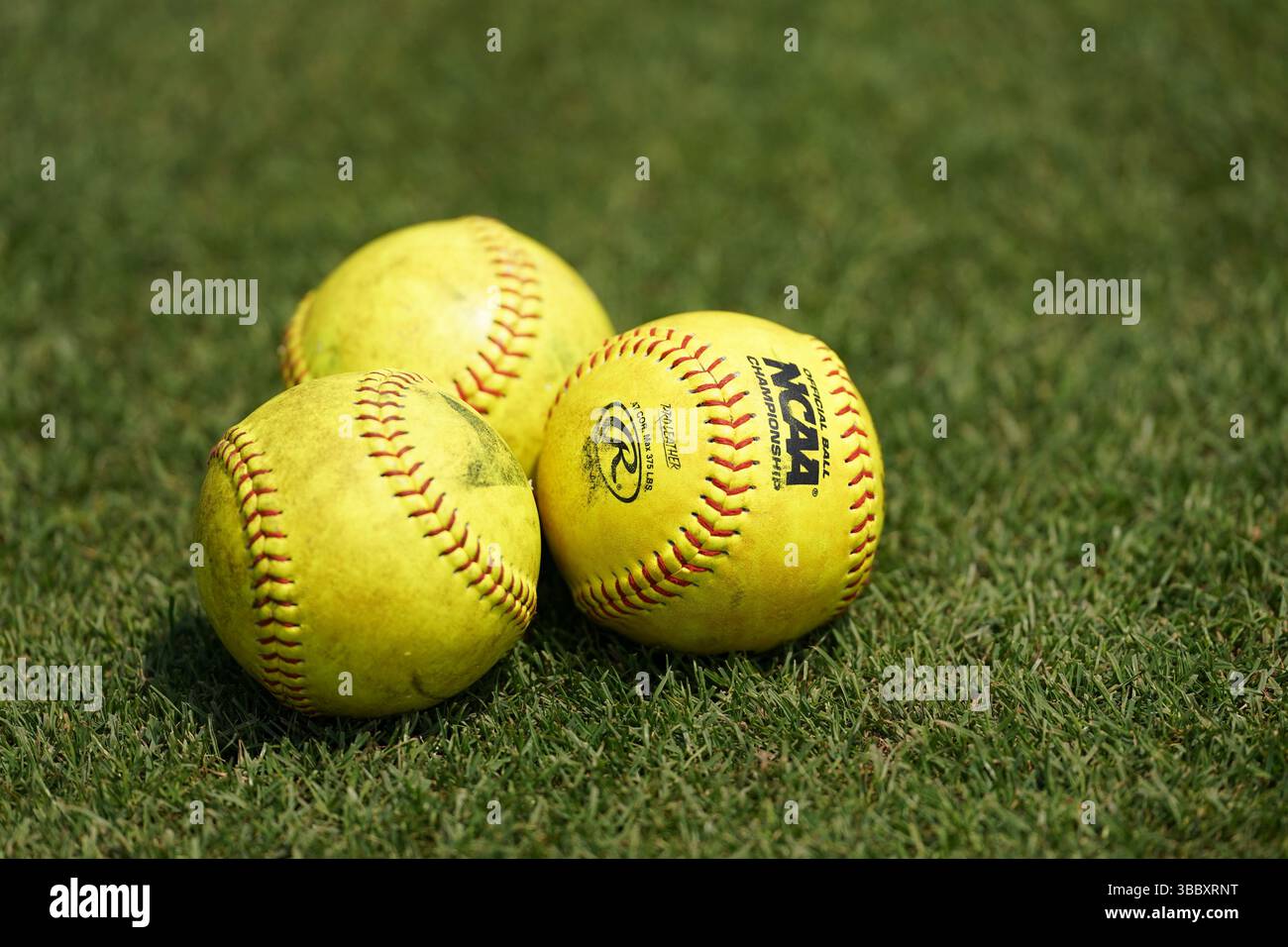 Balls sit on the field before an NCAA regional softball game between ...