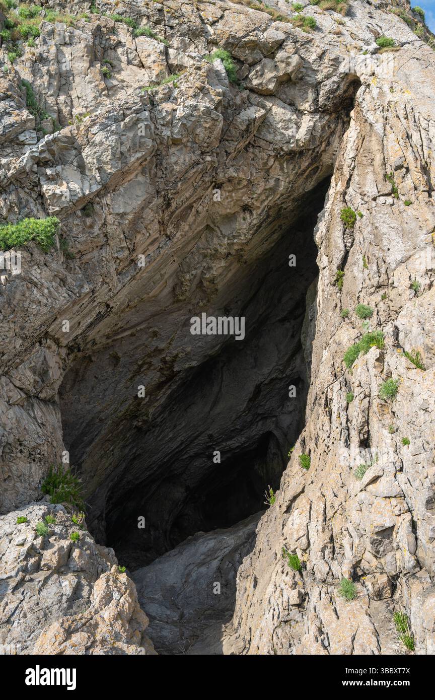 Entrance to Paviland or Goats Hole Cave, South Gower cliffs, Wales, UK ...