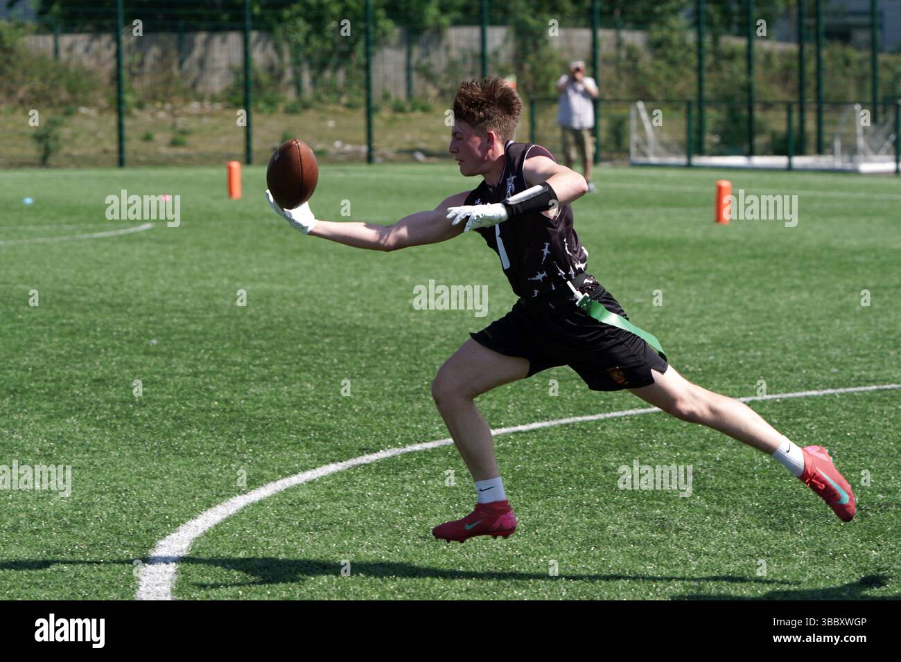 Concentrating on the catch whilst playing flag football in Cardiff ...