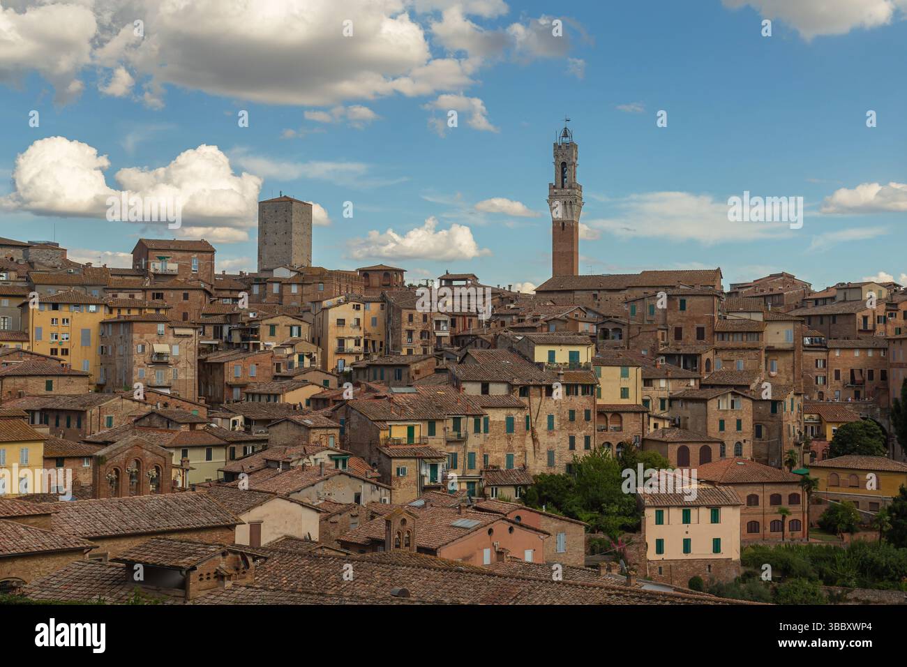 Historic Italian townscape with medieval towers under a bright blue sky ...