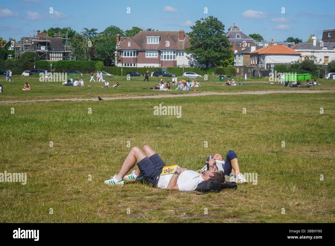 London, UK. 17 May 2025. People relaxing in the afternoon sunshine on ...