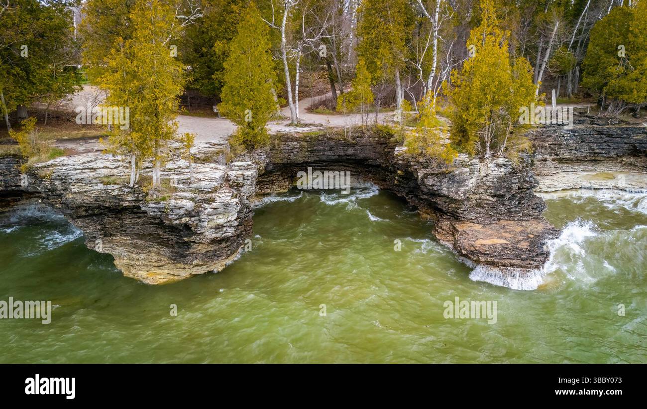 View from the water showing the rugged limestone cliffs and rocky ...