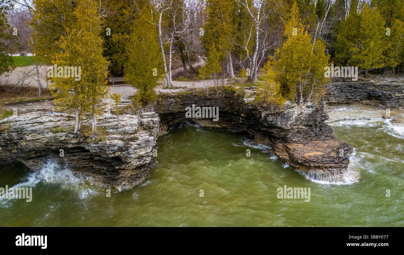 View from the water showing the rugged limestone cliffs and rocky ...