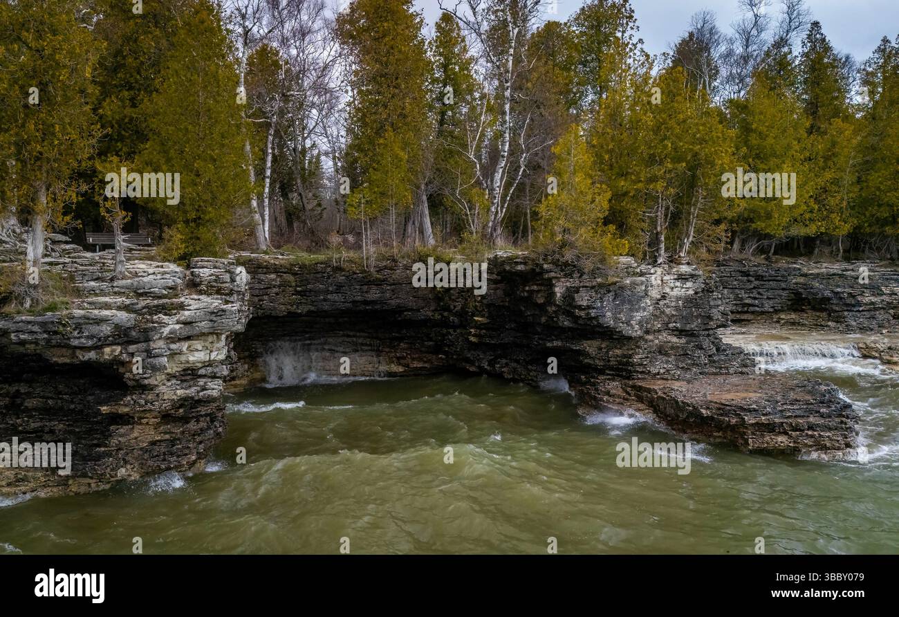 View from the water showing the rugged limestone cliffs and rocky ...