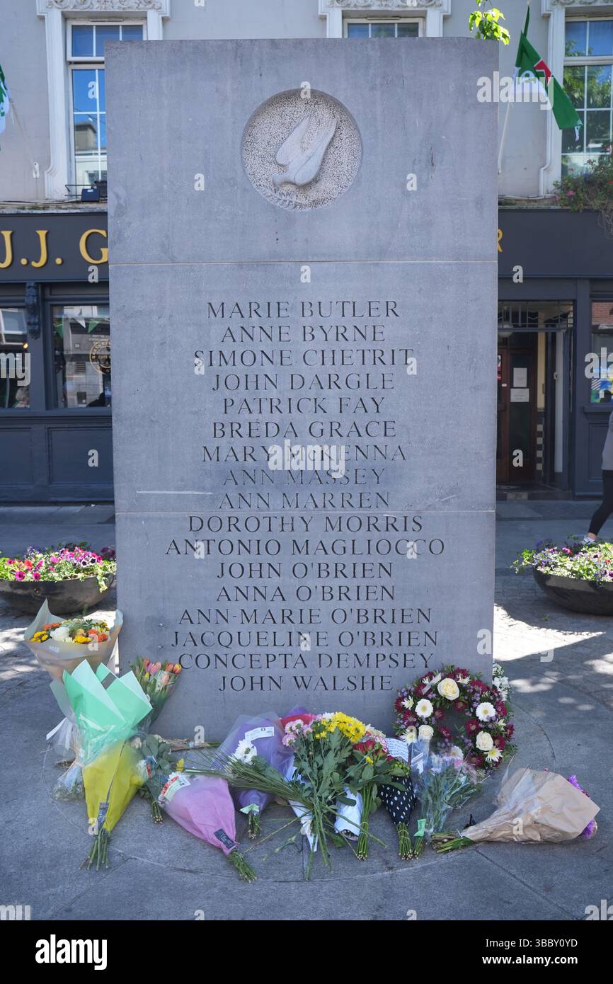 Flowers and tributes laid at the Dublin and Monaghan Bombings Memorial ...