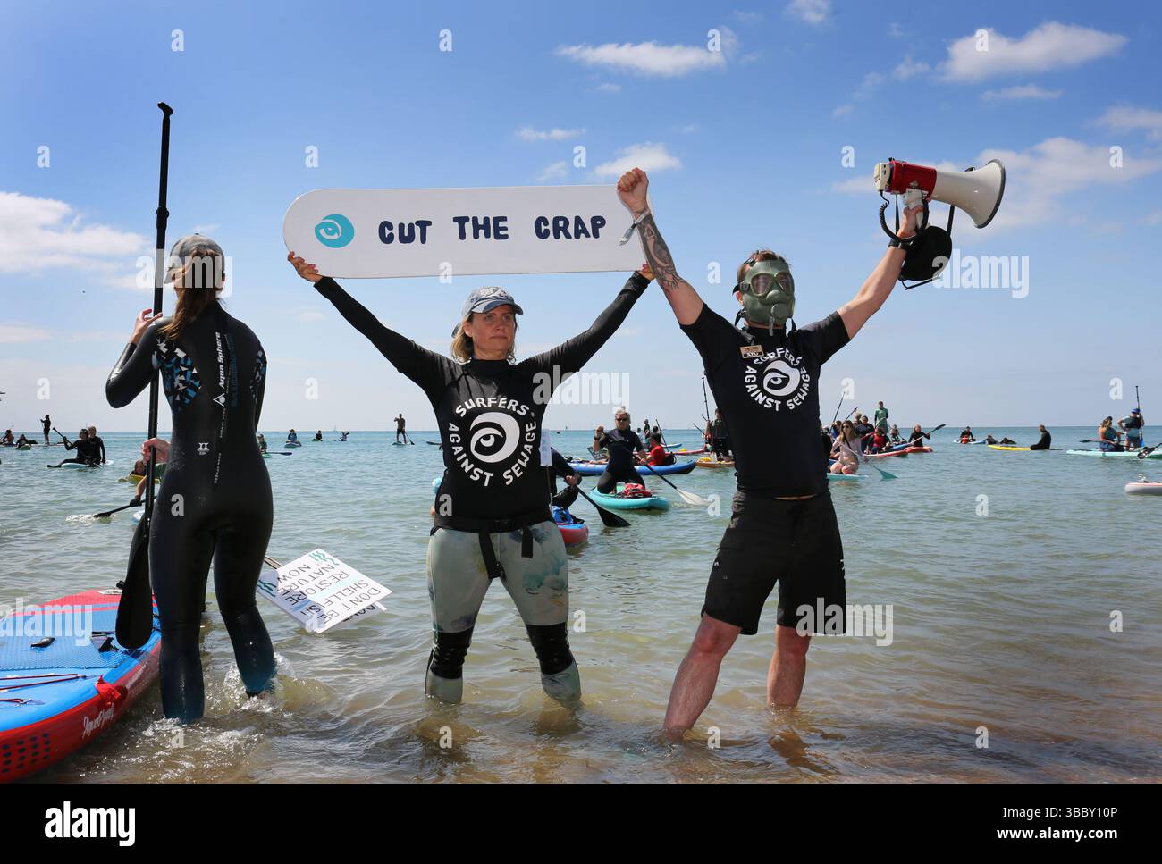 Brighton, England, UK. 17th May, 2025. A protester in a gas mask holds ...