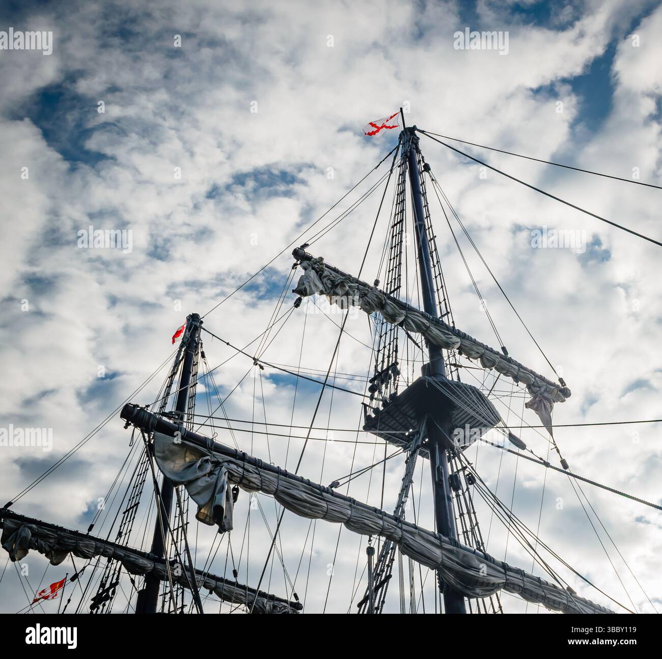 Upward view of tall ship rigging flying a Canadian flag reaching up to ...