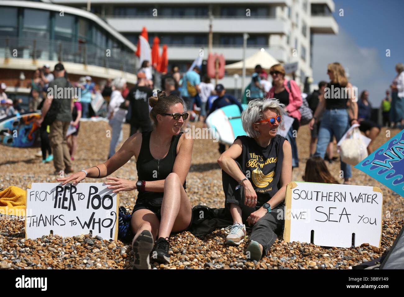 May 17, 2025, Brighton, England, UK: Protesters sit on the beach with ...