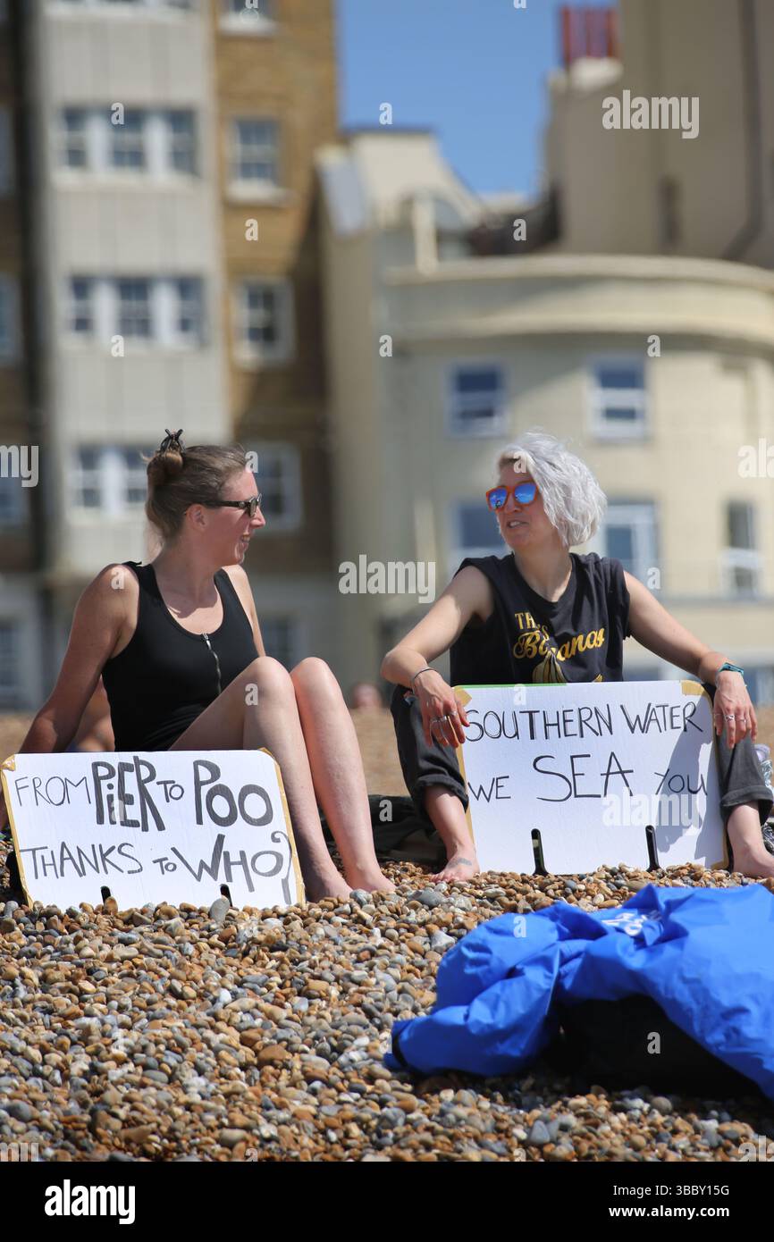 May 17, 2025, Brighton, England, UK: Protesters sit on the beach with ...