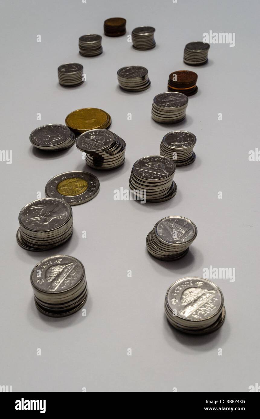 Vertical frame of short stacks of coins leading off into the distance ...