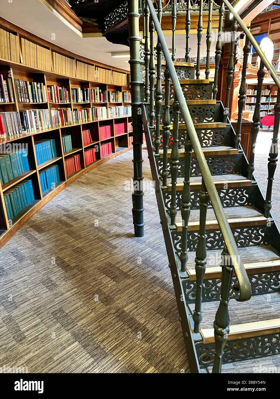 Ornate curved metal stairs with curved bookcases and books in Liverpool Central Library Picton ...
