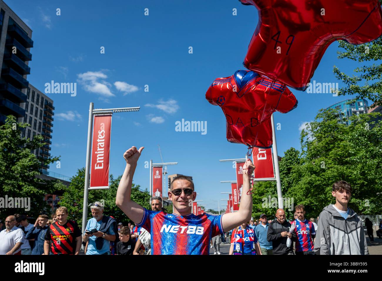 London, UK. 17 May 2025. A Crystal Palace fan with birthday balloons in ...