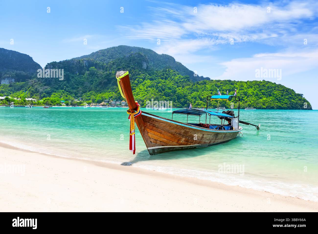 Thai traditional wooden longtail boat and beautiful sand beach in Phi ...