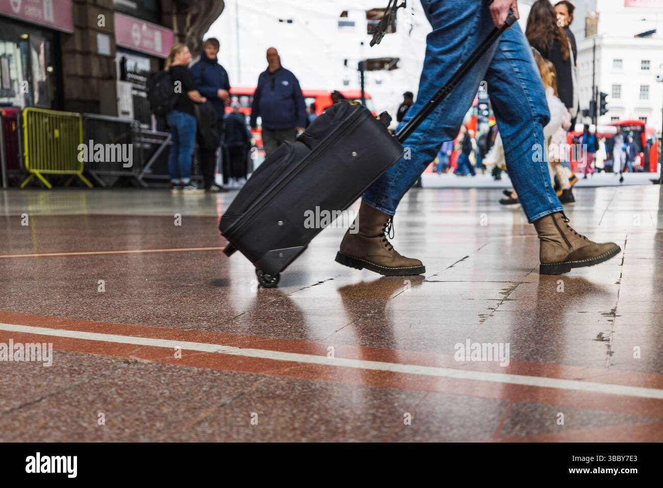 Busy Train Station Scene with Traveler Pulling Rolling Suitcase Through ...