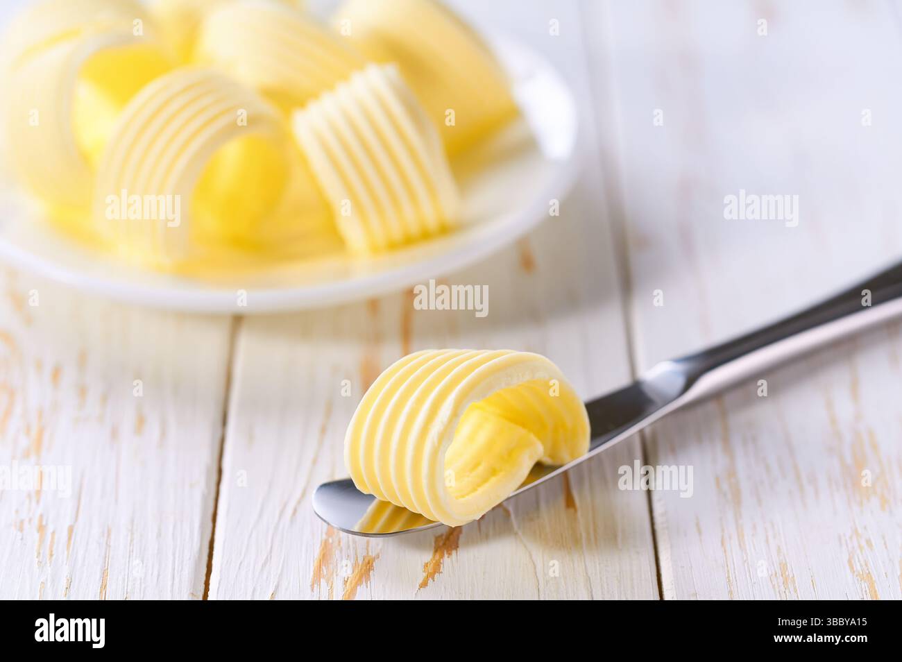 butter swirls in a plate. margarine or spread, fatty natural dairy ...