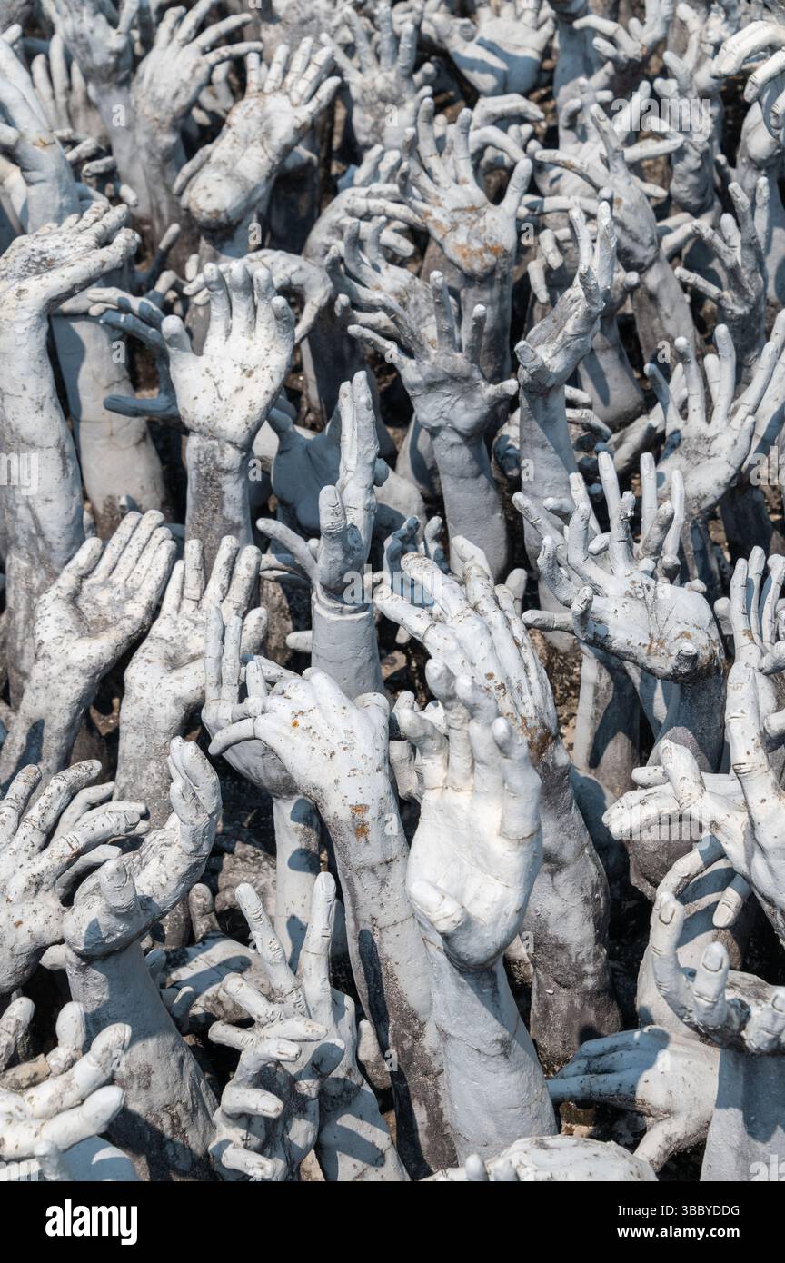 Sculptured raised hands that symbolize unrestrained desire.at the Wat ...