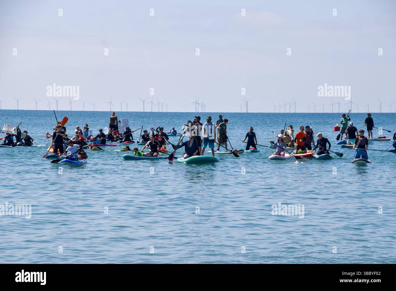 Brighton, UK. 17th May, 2025. Protesters gather in the sea on paddle ...