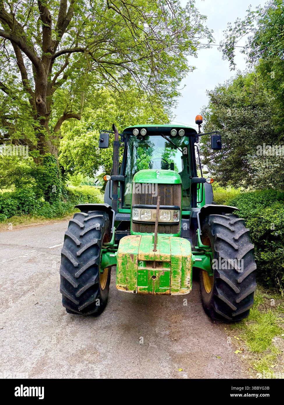 A John Deere tractor on a country lane in England, U.K Stock Photo - Alamy