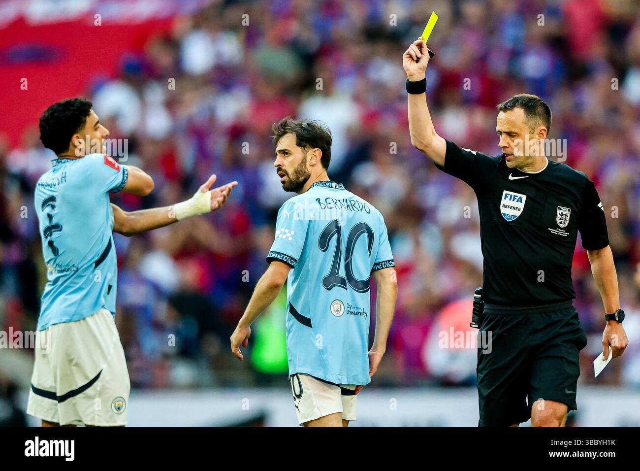 London, UK. 17th May, 2025. Referee Stuart Attwell shows Bernardo Silva ...